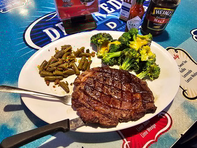 The prime rib that commands respect, served on a table that celebrates American road culture. This isn't dinner &ndash; it's manifest destiny on a plate.
