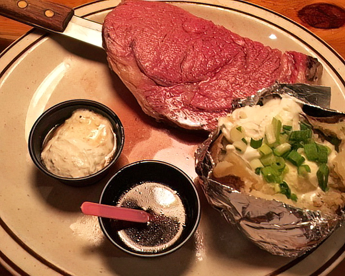 The star of the show arrives: prime rib so perfectly pink it should have its own Instagram account, accompanied by a loaded potato that's dressed for the occasion.