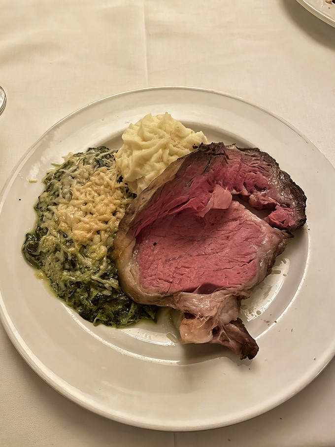 Behold the star of the show: prime rib so perfectly pink it makes vegetarians question their life choices, flanked by creamy spinach and mashed potatoes.