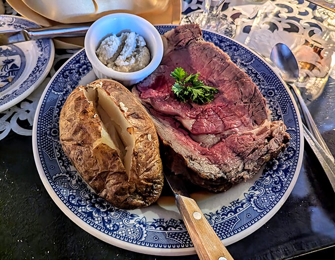 The prime rib arrives like royalty on blue willow china &ndash; a perfectly pink centerpiece with a baked potato sidekick that deserves its own fan club. 