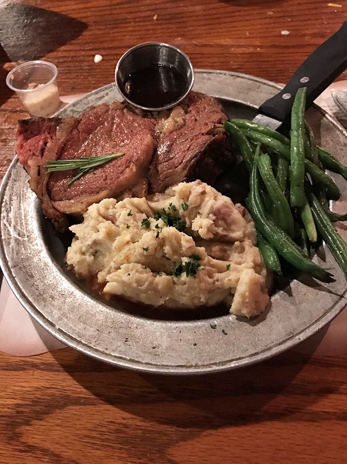 Prime rib that makes vegetarians question their life choices. Perfectly pink, accompanied by creamy mashed potatoes and green beans that actually taste like vegetables.