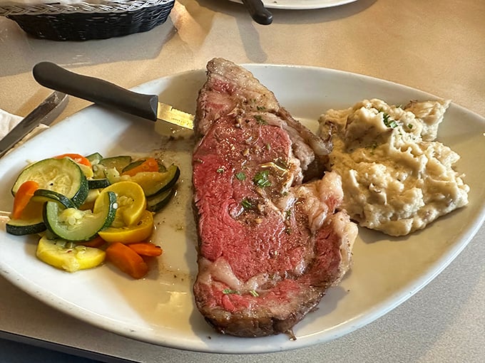 Prime rib perfection that would make a vegetarian weep. This glorious slab of beef, perfectly pink and herb-crusted, is worth the drive from anywhere.