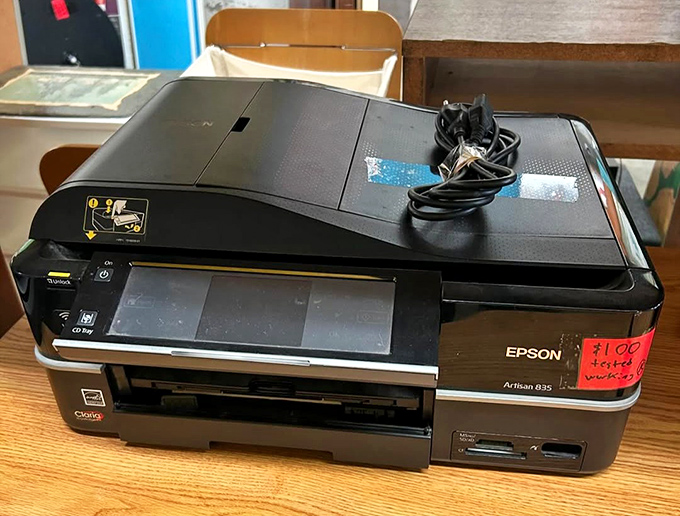 Technology's retirement home! This Epson printer probably printed someone's college thesis before landing here, ready for its encore performance in your home office.