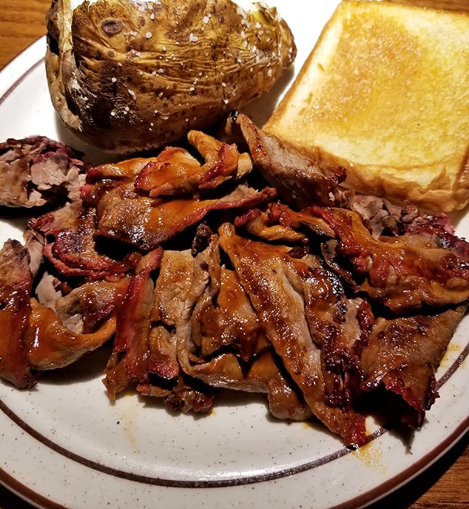 Tender, smoky pulled pork that practically dissolves on contact &ndash; this isn't just barbecue, it's edible poetry with a side of Texas toast.