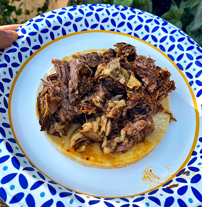 Behold the star of the show: carnitas so perfectly rendered they practically glisten, nestled on a tortilla like meaty treasure.