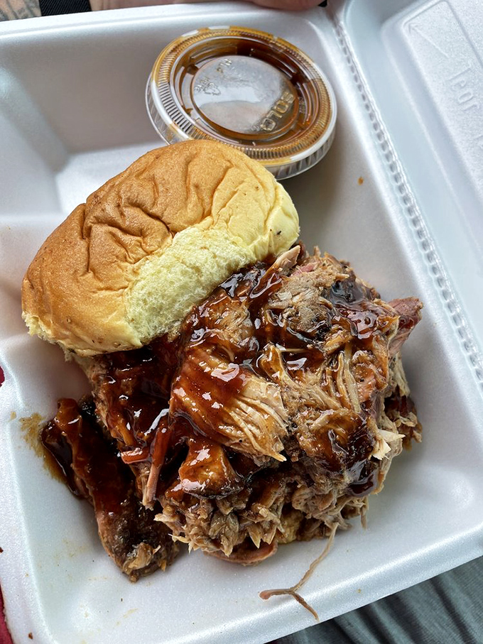 This pulled pork sandwich isn't just food&mdash;it's an architectural marvel of tender, sauce-kissed meat that's practically bursting from its bun.