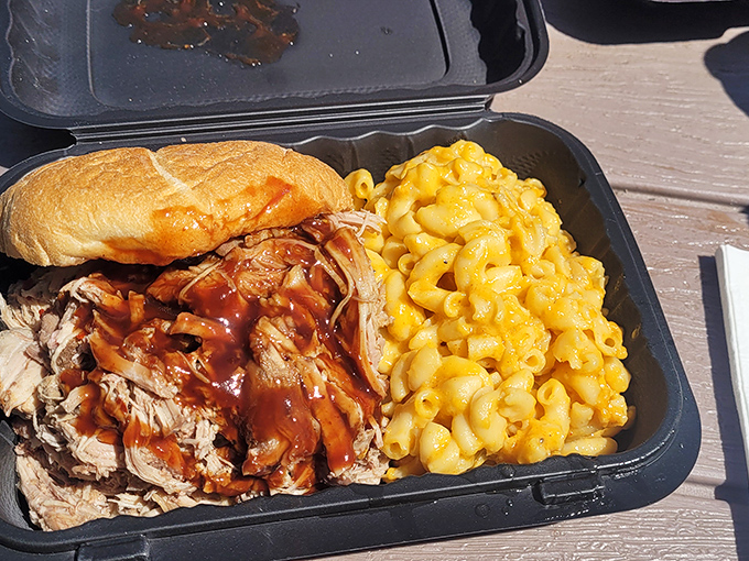 This isn't just pulled pork&mdash;it's a masterclass in meat. The sauce glistens with promise while the mac and cheese stands by, ready for its supporting role in your happiness.