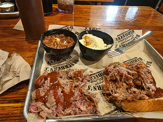 Pulled pork so tender it practically surrenders to your fork, served alongside creamy sides that know their supporting role but still manage to steal scenes.