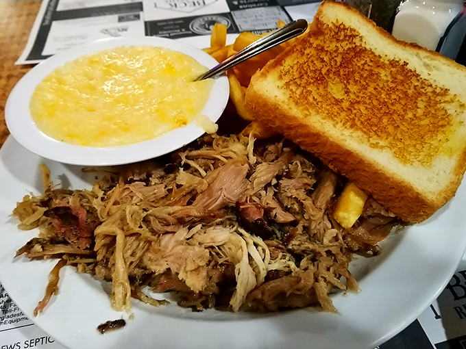 Pulled pork with that perfect bark-to-meat ratio, alongside creamy grits that would make any Southern grandmother nod in approval.