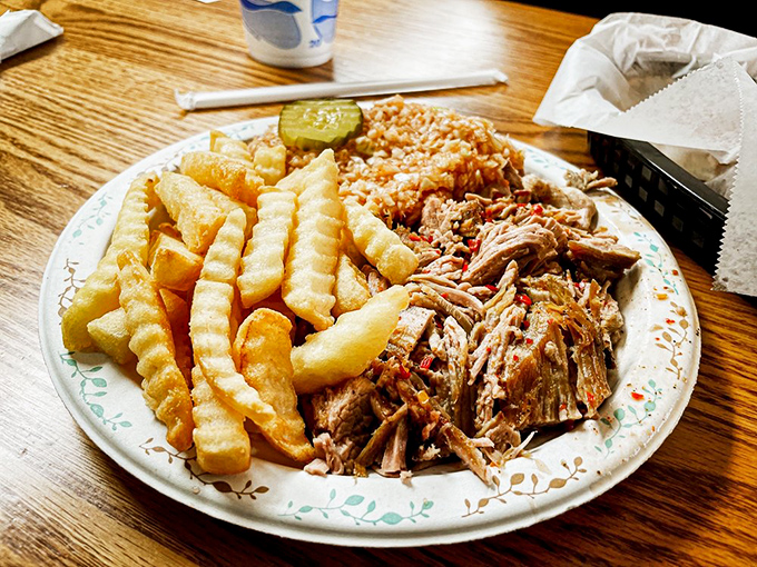 Behold the holy trinity of Southern comfort: pulled pork with that pink smoke ring, golden fries, and that little pickle&mdash;nature's palate cleanser.