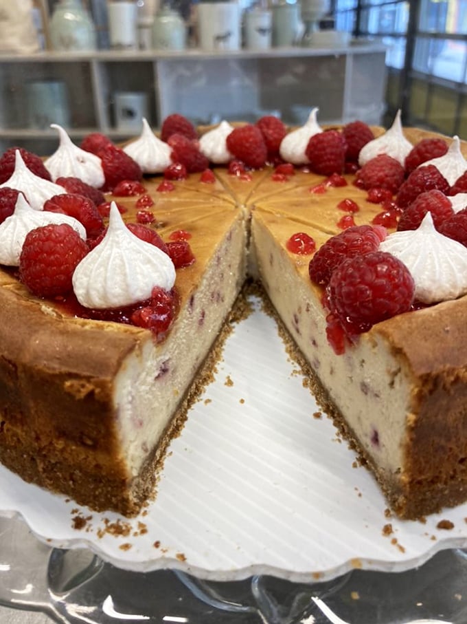 This raspberry champagne cheesecake isn't just dessert—it's edible architecture. Those perfect meringue kisses and fresh berries deserve their own museum.