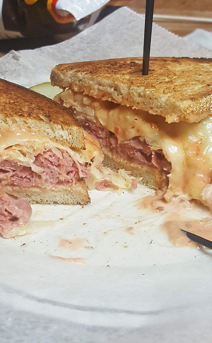 This Reuben isn't just a sandwich; it's a masterpiece of balance where corned beef, sauerkraut, and melted Swiss perform a perfectly choreographed dance.