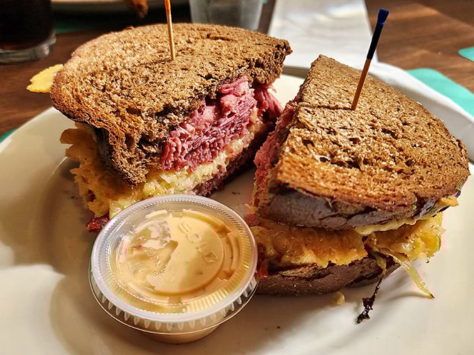 The legendary Reuben in all its glory &ndash; a skyscraper of corned beef requiring both hands, engineering skills, and absolutely zero concern for your shirt's cleanliness. 