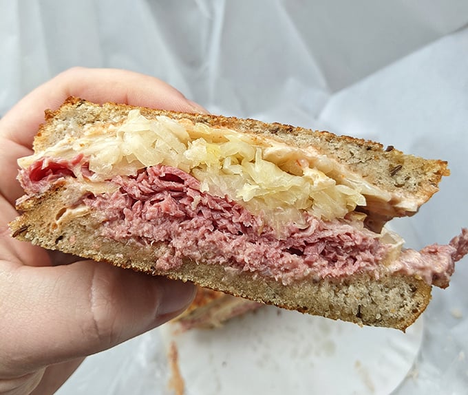 The holy grail of sandwiches &ndash; layers of pink corned beef, sauerkraut, and melted Swiss on rye. Napkins required, restraint impossible.