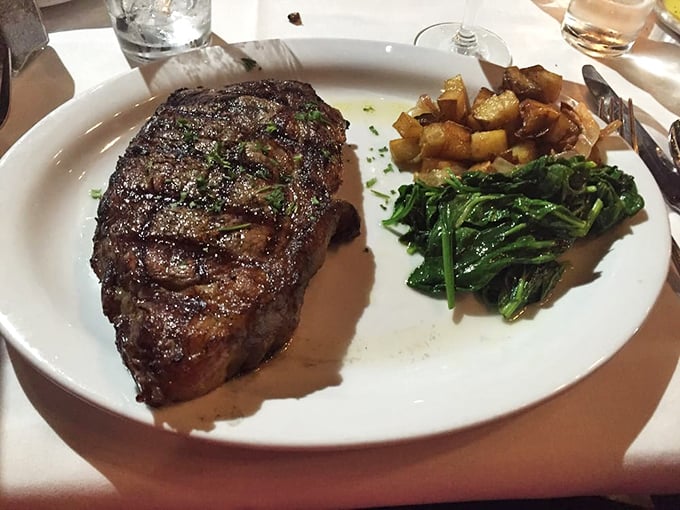 Behold the star of the show: a perfectly seared ribeye with just the right amount of char, accompanied by sides that know their supporting role.