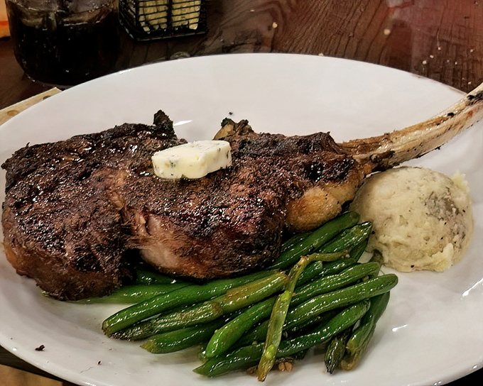 This bone-in beauty isn't just a steak&mdash;it's a masterpiece of marbling, crowned with a melting pat of butter that's performing a slow, seductive dance.