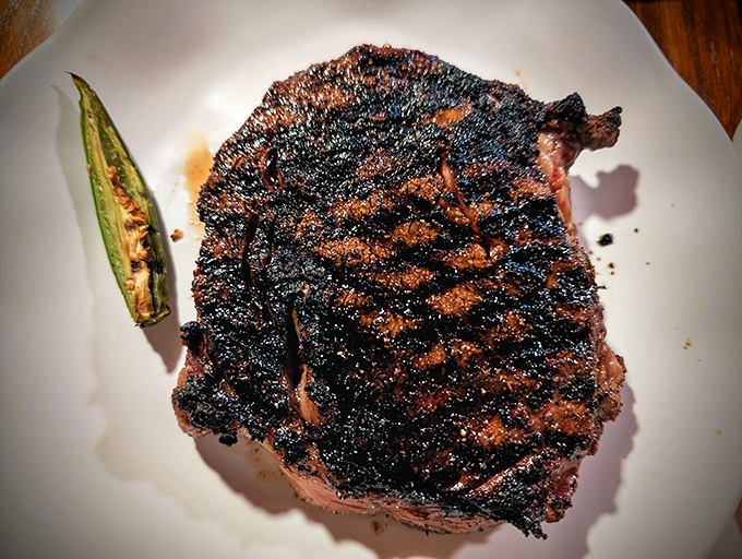 This isn't just a steak; it's a masterpiece of mesquite-grilled perfection. The char marks are like nature's signature on a work of art.