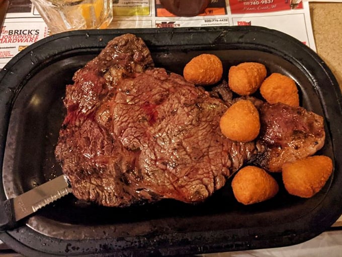 Behold the star of the show&mdash;a perfectly seared ribeye accompanied by golden cheese curds. This isn't just dinner; it's a Wisconsin rite of passage.