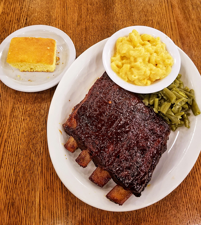 These ribs don't just fall off the bone—they practically leap into your mouth, bringing along mac and cheese that would make your childhood self weep with joy.