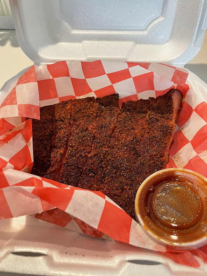 Behold the bark! This brisket's peppery crust is the result of patience, smoke, and barbecue wisdom. That little cup of sauce? Totally optional.