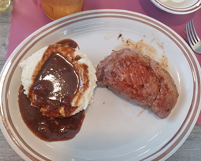 That mashed potato volcano erupting with gravy alongside a perfectly cooked steak? This is the plate that would make your cardiologist wince and your soul sing.