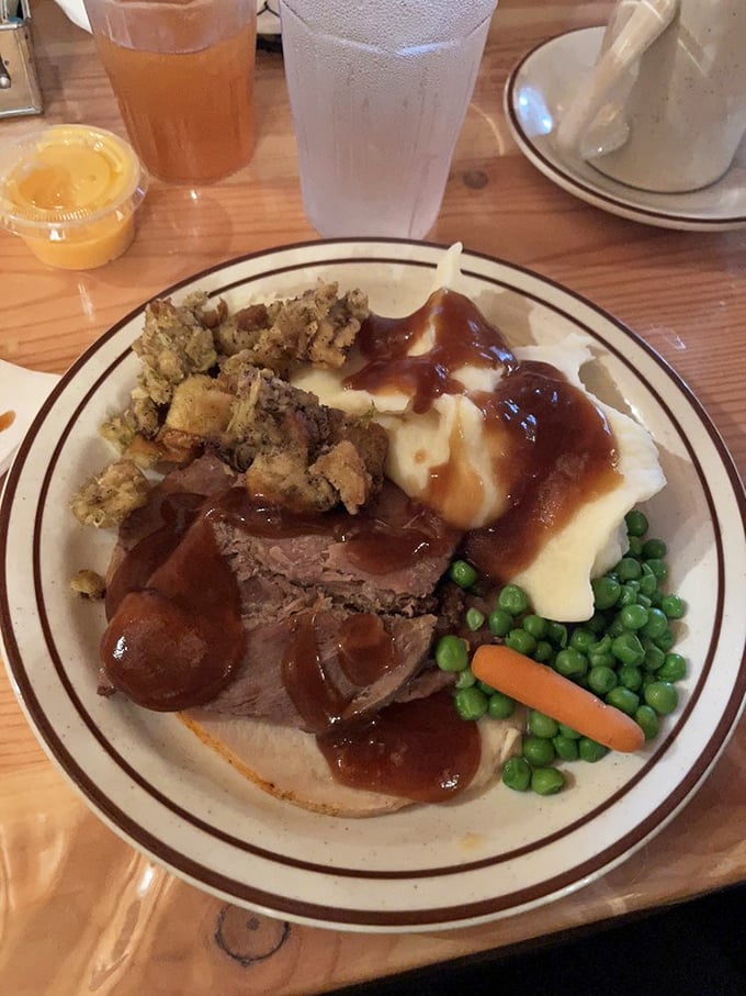 Behold the star attraction: tender roast beef swimming in rich gravy alongside fluffy mashed potatoes. This plate doesn't just satisfy hunger&mdash;it soothes the soul.