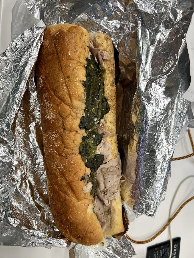 Behold the roast pork sandwich with broccoli rabe&mdash;a masterpiece wrapped in foil. This isn't lunch; it's an edible work of art.