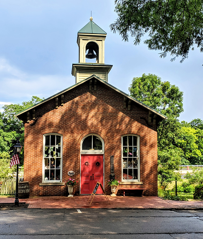 This adorable brick schoolhouse with its classic bell tower looks like something straight from a Norman Rockwell painting.