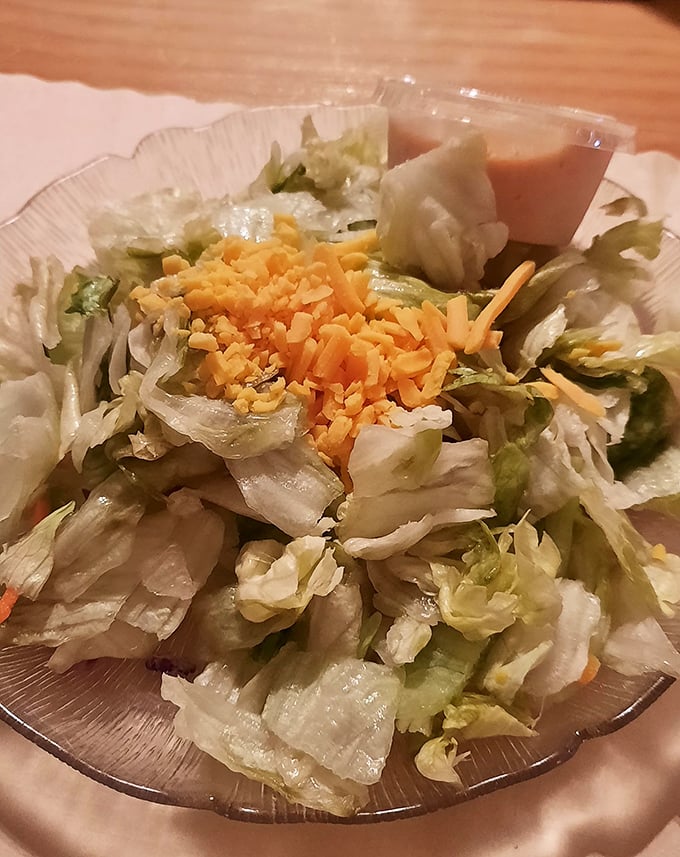 This unassuming salad might not win beauty contests, but that shredded cheddar and house dressing are the opening act to a classic supper club experience.