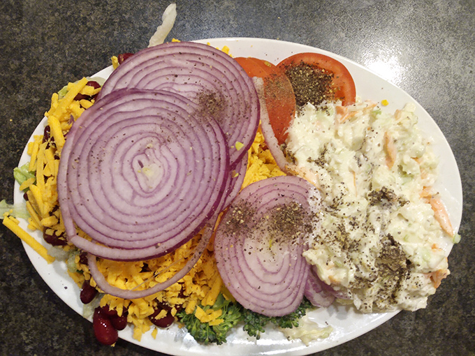A salad bar masterpiece that would make any buffet enthusiast weak at the knees&mdash;those purple onion rings are practically jewelry for your lettuce.