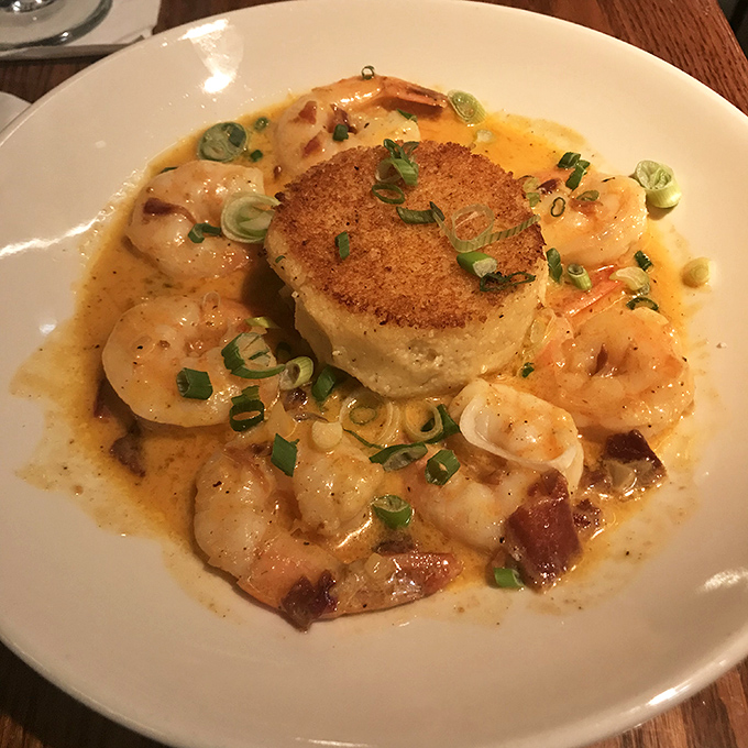 The legendary scallop dish arrives like culinary poetry – perfectly seared medallion surrounded by plump shrimp in a buttery sauce that demands bread-sopping.
