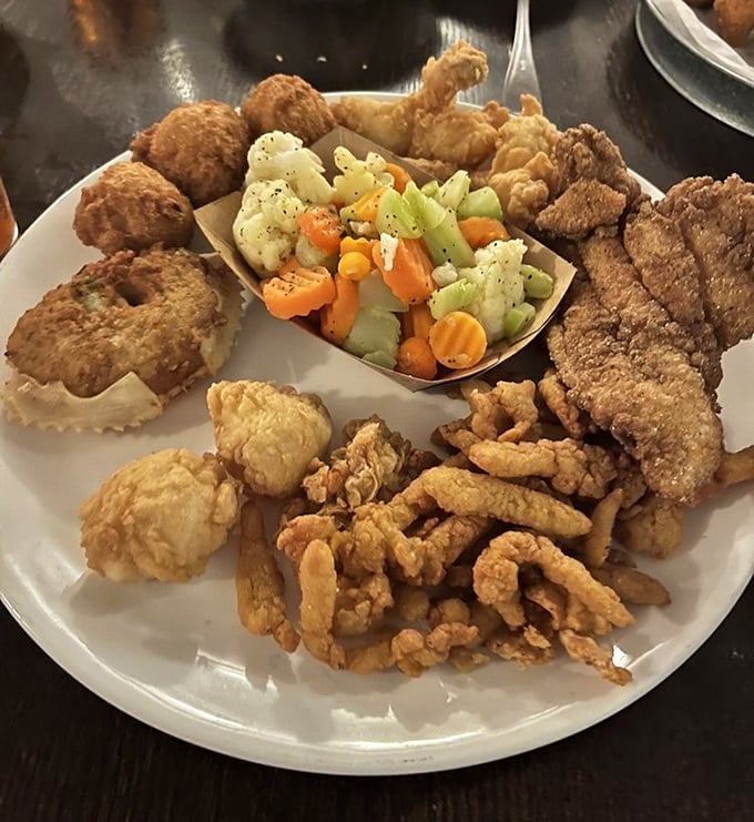 Seafood nirvana on a single plate! Golden-fried treasures surround fresh vegetables like a delicious moat protecting a castle of flavor.
