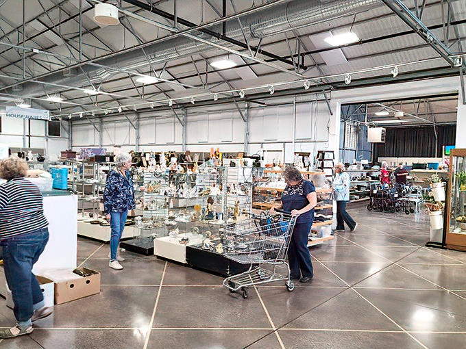 Serious shoppers navigate the glassware section with the concentration of archaeologists, each cart filling with domestic artifacts from decades past.