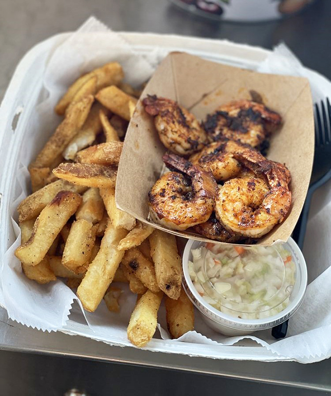 These blackened shrimp aren't just cooked, they're celebrated. Served with golden fries and slaw, it's vacation on a plate, no passport required.