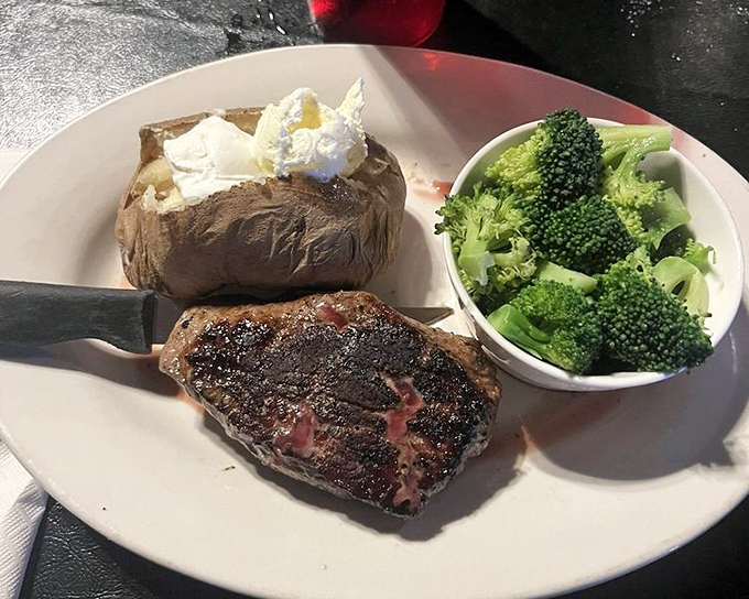 A perfectly seared sirloin reveals its blushing interior, while the loaded baked potato and bright broccoli maintain Missouri's delicate balance of indulgence and virtue.