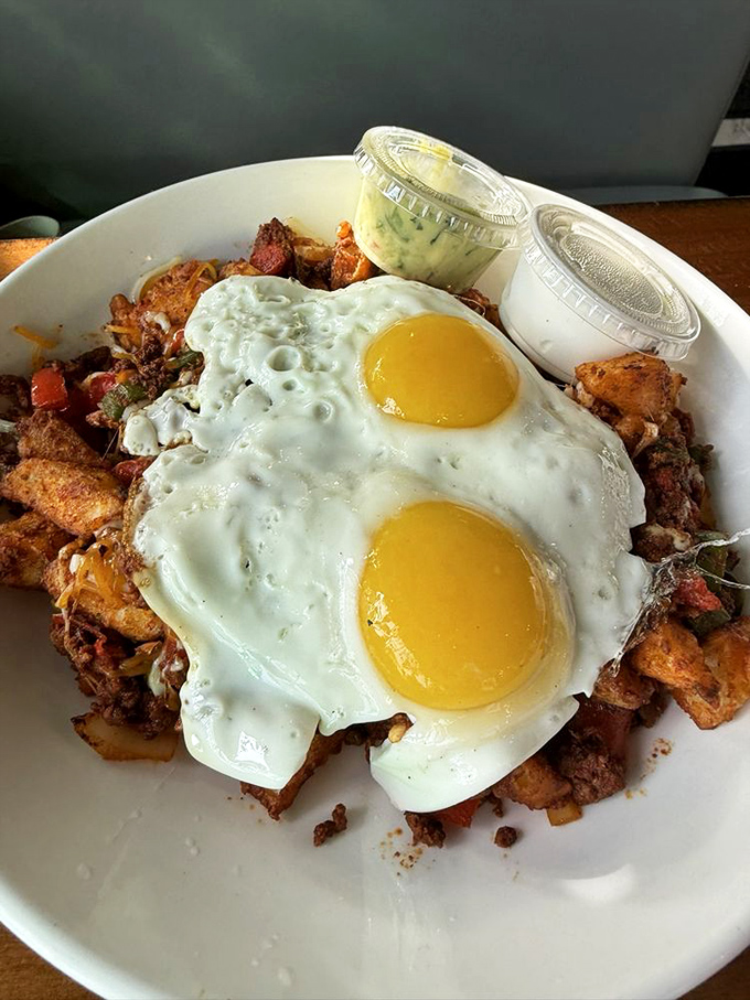 Behold the skillet in all its glory&mdash;two sunny-side-up eggs crowning a kingdom of crispy potatoes and savory treasures below. Morning royalty, served.