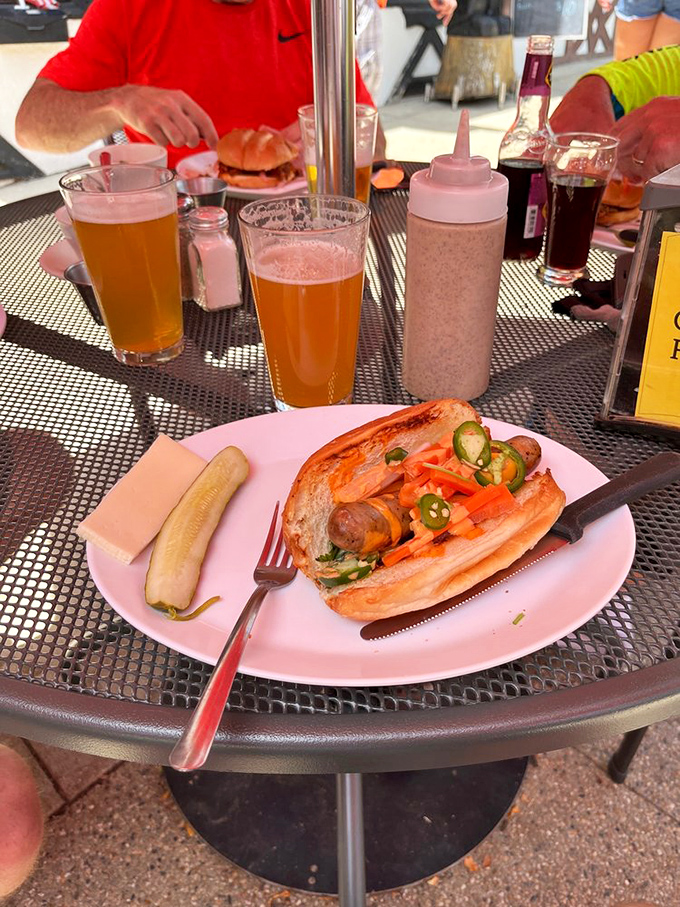 Summer's perfect companion: a local smoked brat loaded with toppings, paired with cold beer and zero pretension. Wisconsin on a plate.