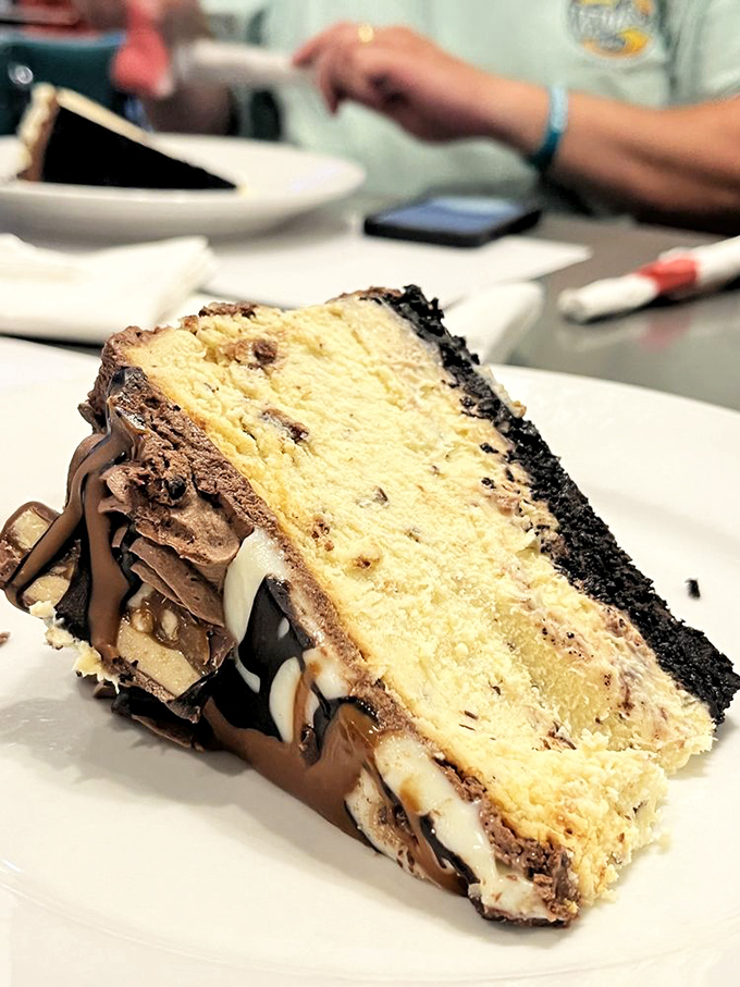 Not all heroes wear capes—some come layered with chocolate, cookie crumbles, and cream cheese in a slice that requires both hands.
