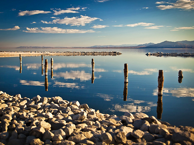 Mirror-like waters of the Salton Sea create perfect reflections of weathered pilings &ndash; a photographer's dream that changes with every passing cloud.