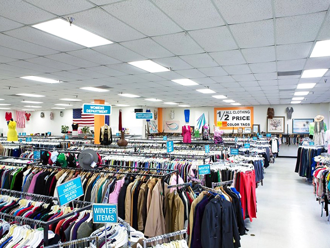 Rack after glorious rack of potential wardrobe upgrades stretching toward the horizon like a textile sea. The signage says it all: half-price heaven.