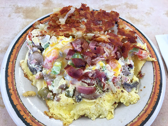 Behold the Special Omelette: a fluffy canvas painted with bacon, ham, and enough cheese to make your cardiologist weep with joy.