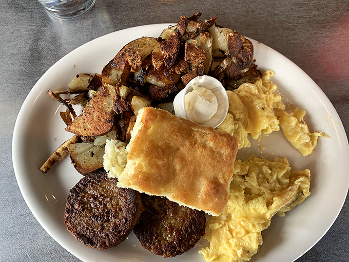 Breakfast of champions! Crispy skillet potatoes, fluffy scrambled eggs, and a biscuit that would make your grandmother question her recipe.