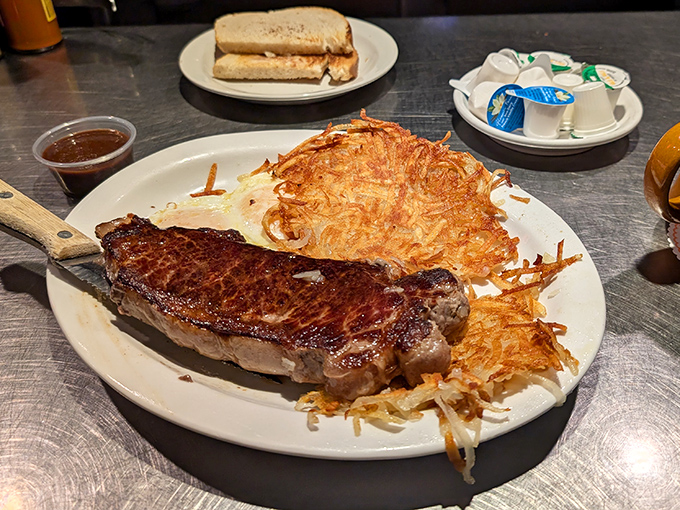 When a steak arrives with hash browns so perfectly crispy they practically form a halo around the meat, you know you've found breakfast heaven.