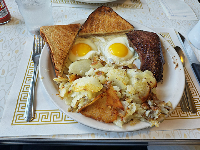 Breakfast perfection doesn't need fancy plating—just perfectly sunny-side-up eggs, golden home fries, and toast that's achieved that magical butter-to-crunch ratio.