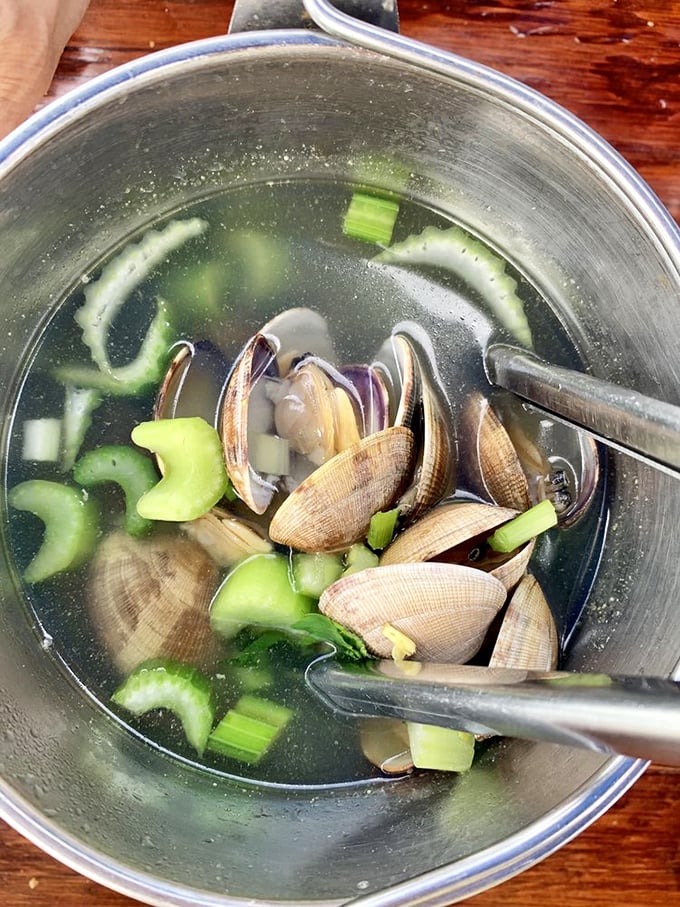These steamed clams aren't just food; they're little oceanic miracles swimming in a broth so good you'll contemplate drinking it straight from the bowl.