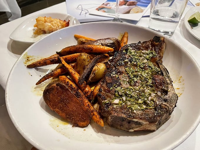 This isn't just a steak; it's a carnivore's sonnet with a herb compound butter slowly melting into perfectly charred beef. Those roasted carrots aren't bad company either.