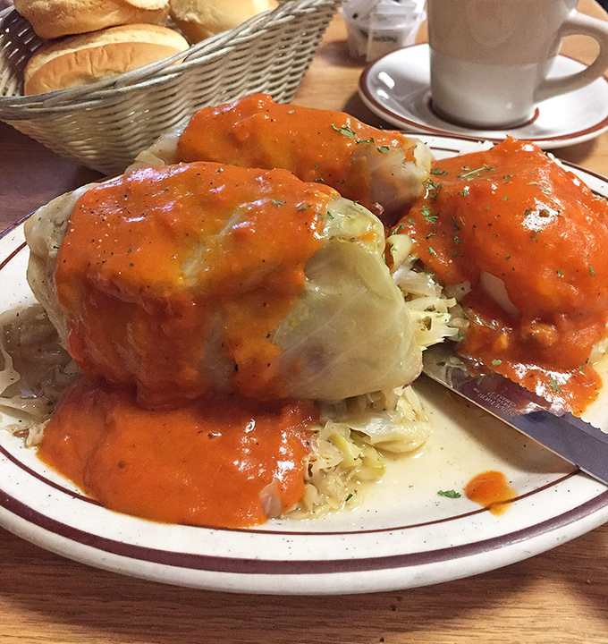 These stuffed cabbage rolls aren't just dinner; they're edible history, swimming in a tomato sauce that could make your grandmother jealous.