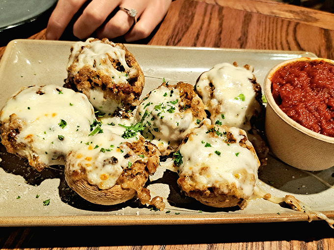 These stuffed mushrooms aren't just appetizers&mdash;they're little silver-dollar stages where cheese performs its most magnificent melting act.