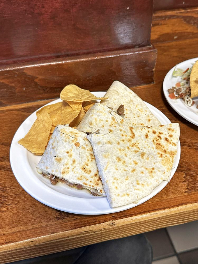 This quesadilla isn't just folded&mdash;it's embraced. Golden-brown tortilla hugging melty cheese and savory fillings like a warm Mexican blanket.