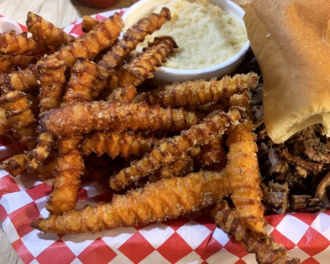 These aren't your average sweet potato fries&mdash;they're crispy, ridged flavor vehicles dusted with cinnamon and sugar. The kind that make conversation stop mid-sentence.